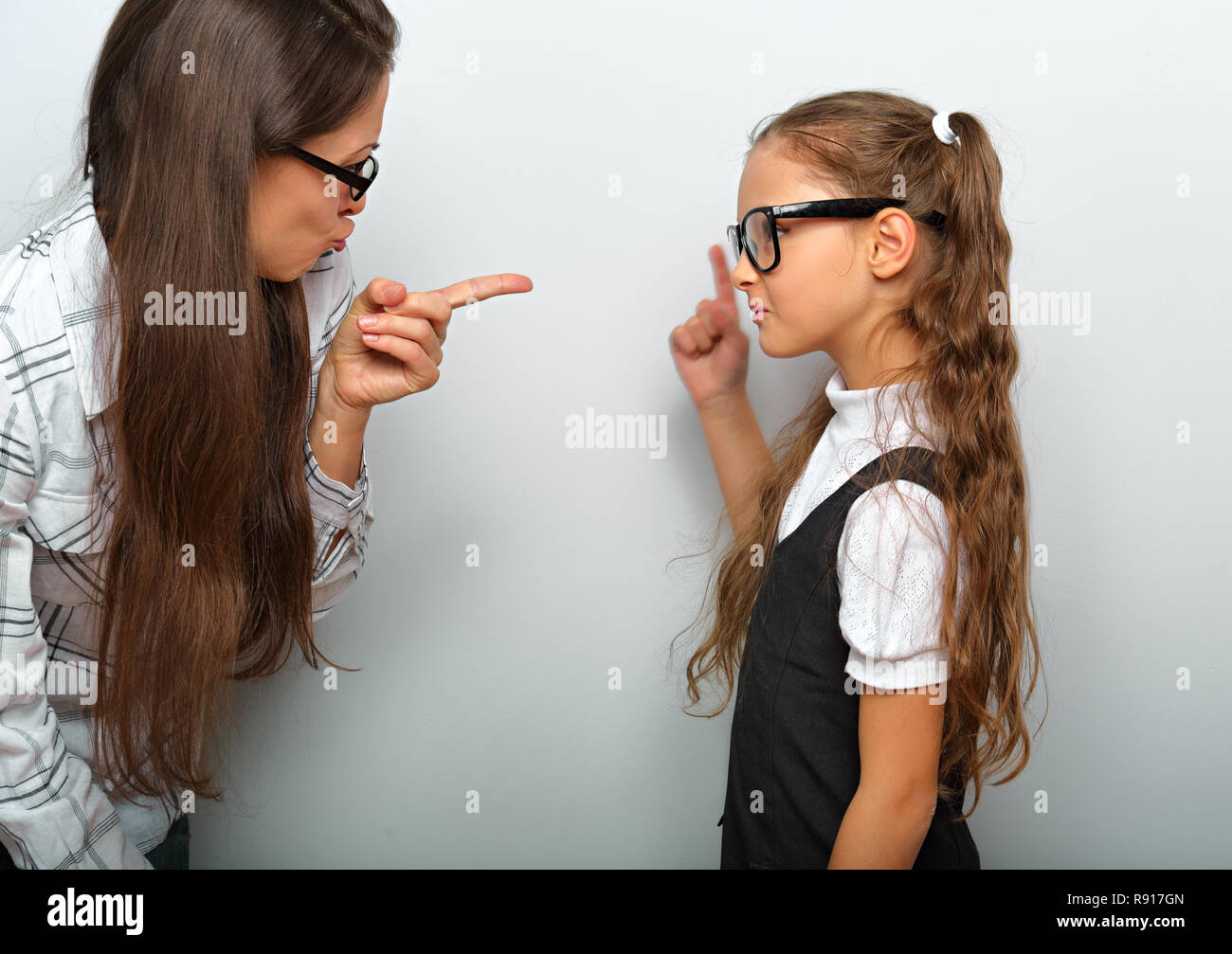 Angry beautiful woman in eye glasses scolding her pupil daughter and ...