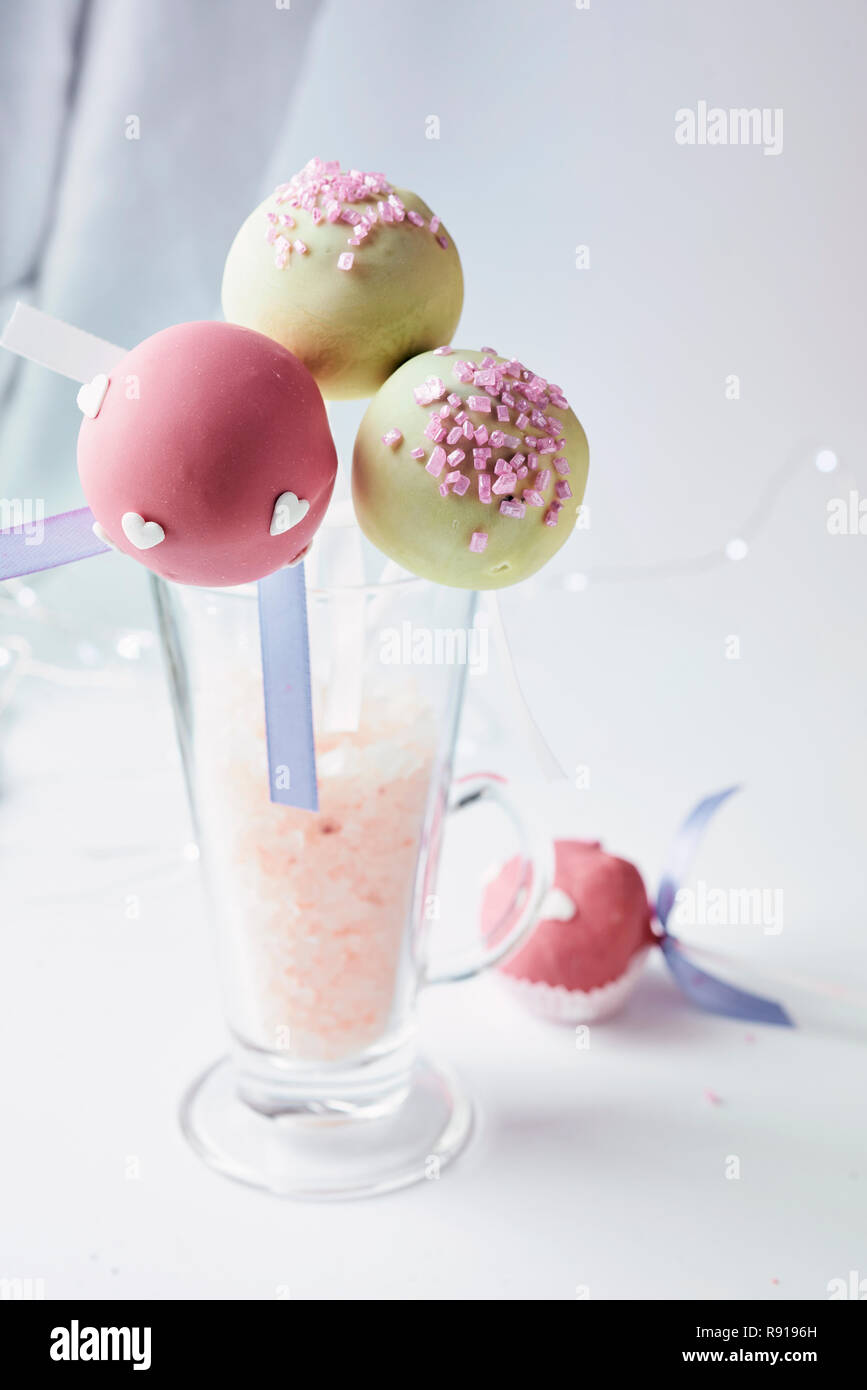 green and pink sweet cake pops with sprinkles Stock Photo - Alamy