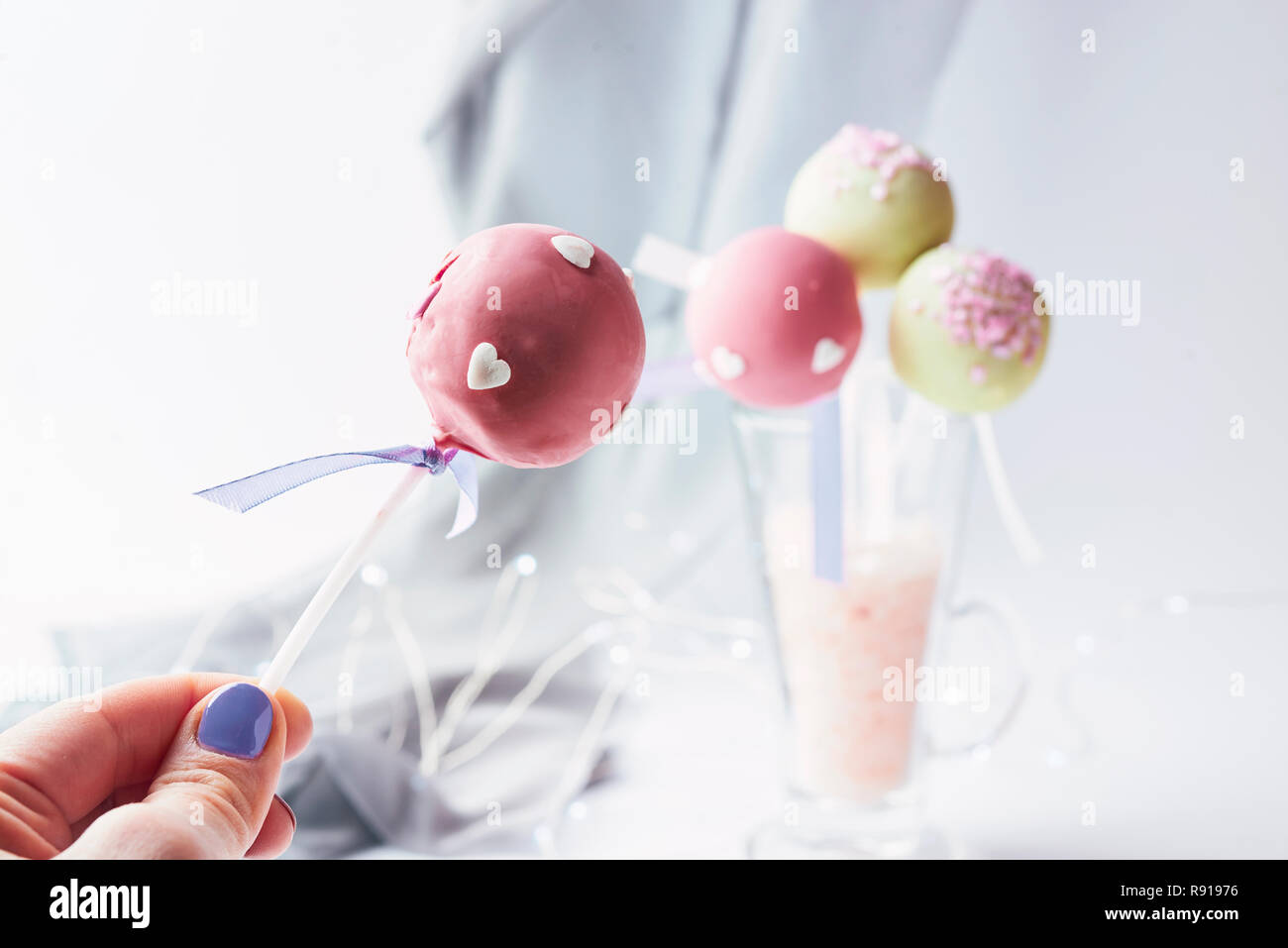 green and pink sweet cake pops with sprinkles Stock Photo - Alamy