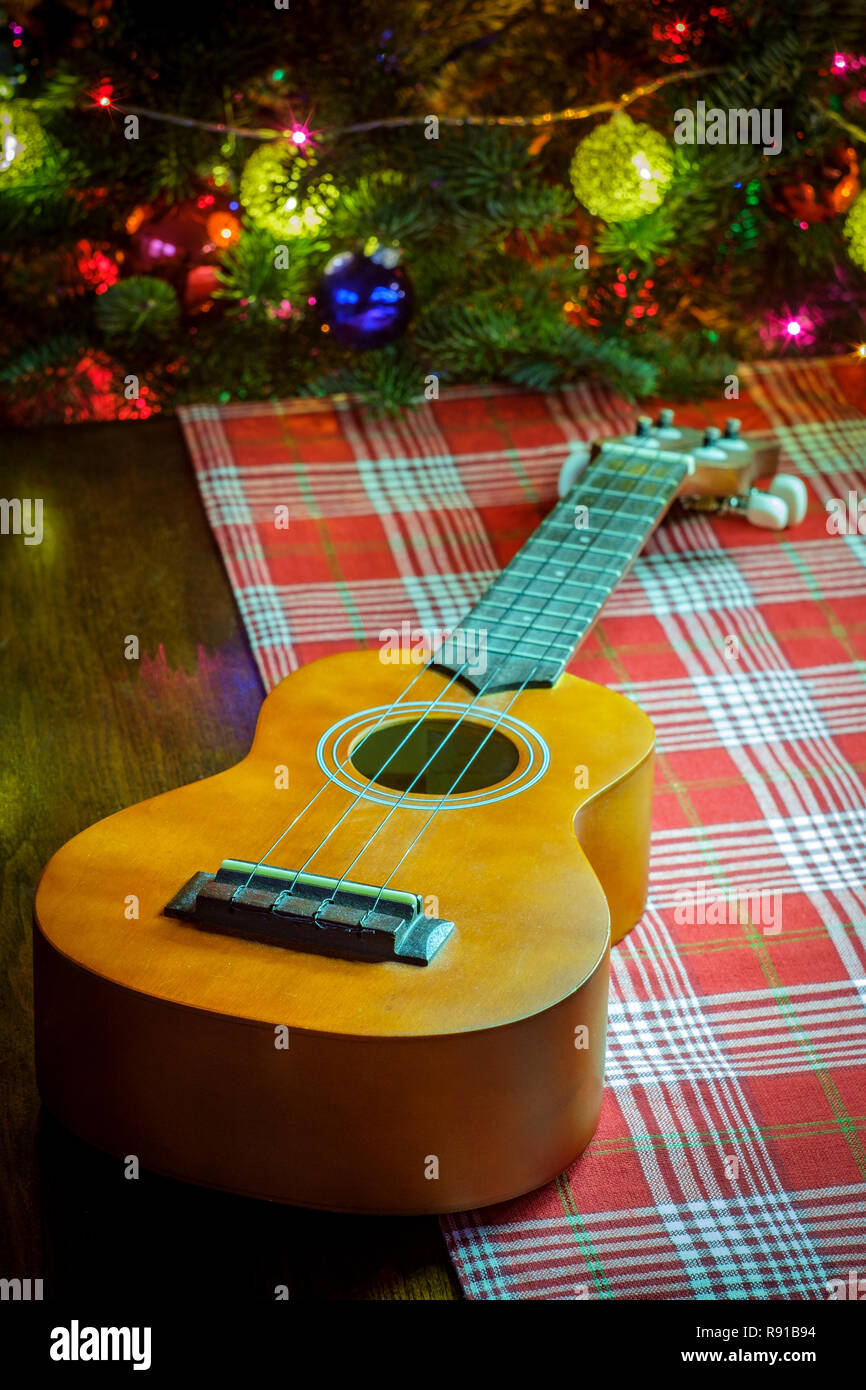Seasonal holiday musical instrument ukulele with Christmas tree ...