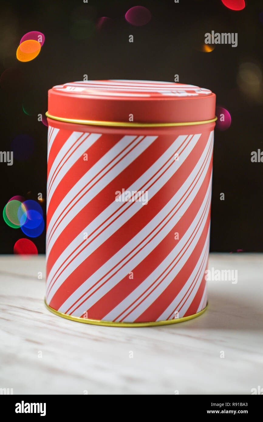 Christmas lights on tree in background with candy cane colored ...