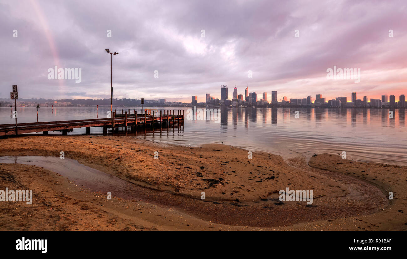 A rainbow and stormy skies over Perth city and the Swan River Stock ...