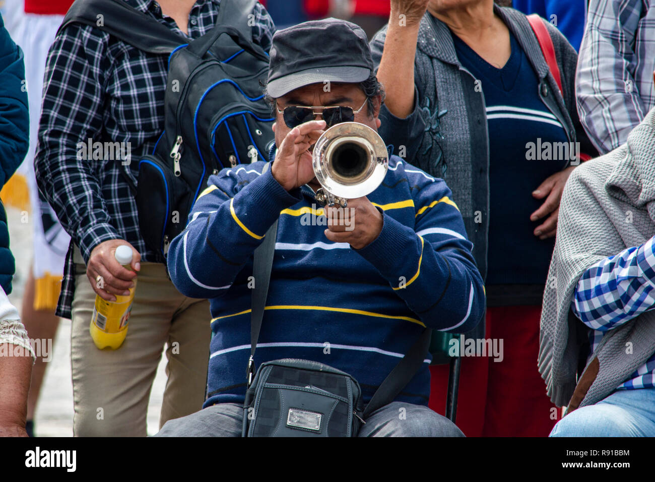 A man playing a trumpet for a Mexican dance at the Basilica of Our Lady ...