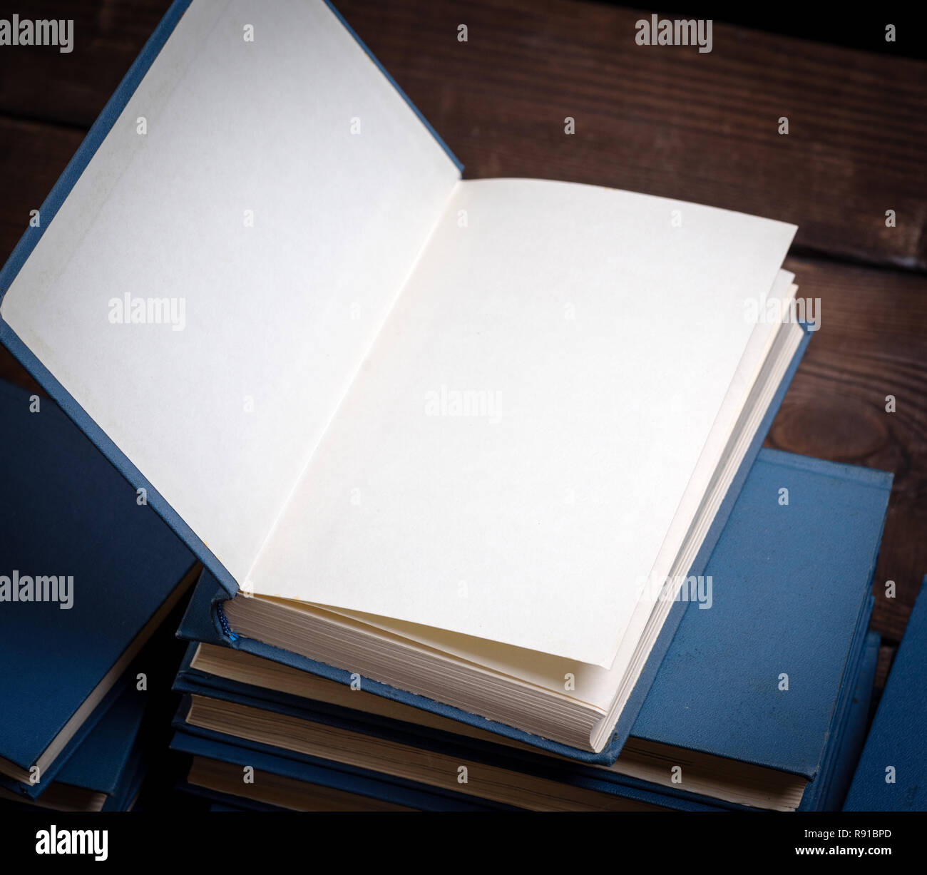 stack of various books, open book on top, top view Stock Photo - Alamy