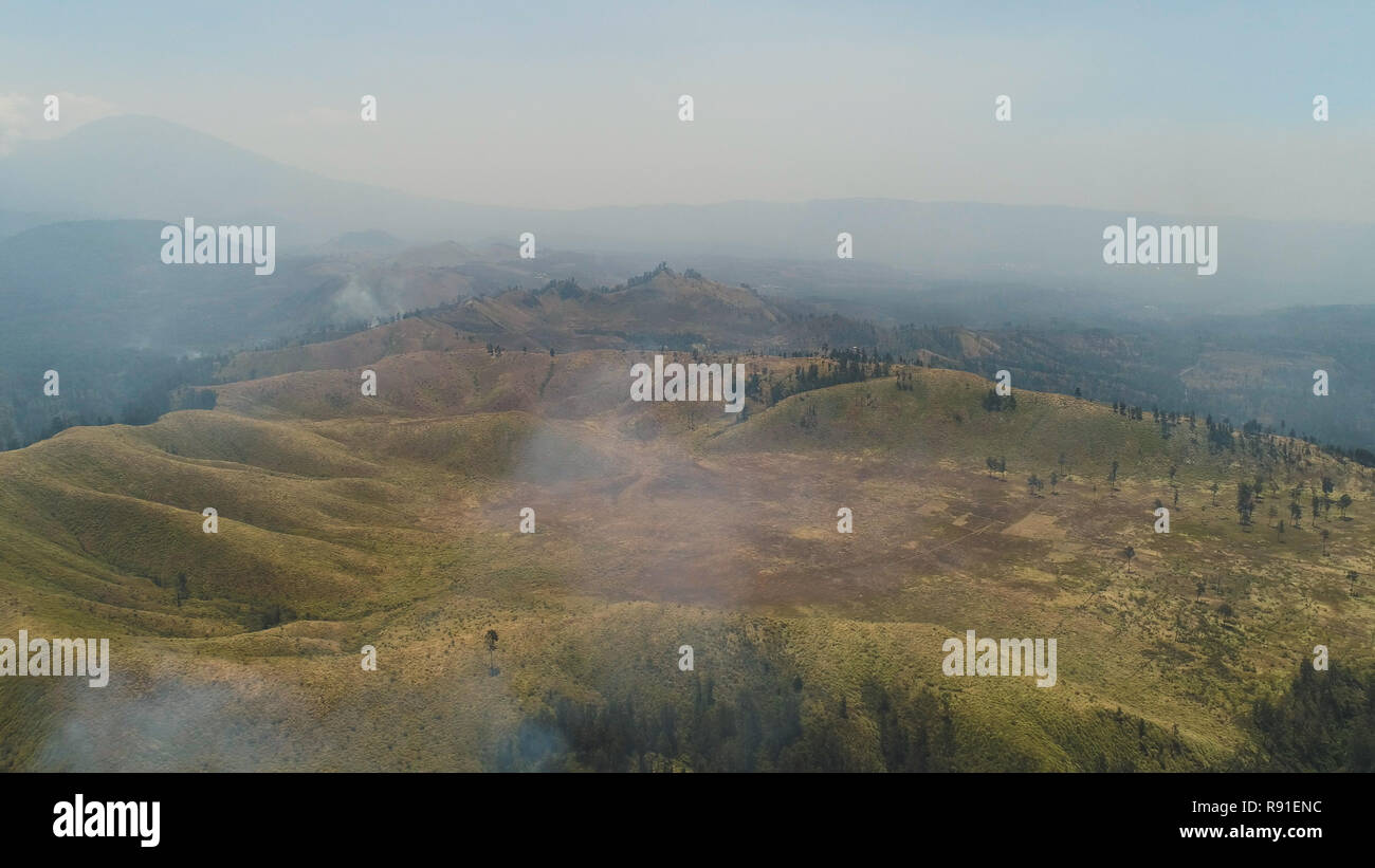 aerial view forest fire smoke on slopes hills. wild fire in tropical ...