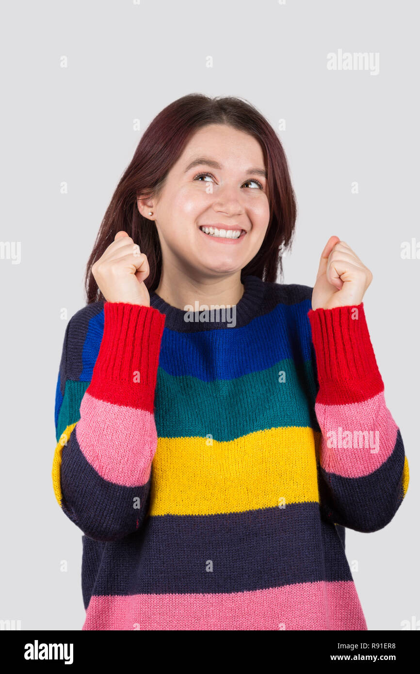 Cheerful excited young student woman looking up and smiling.Happy human ...