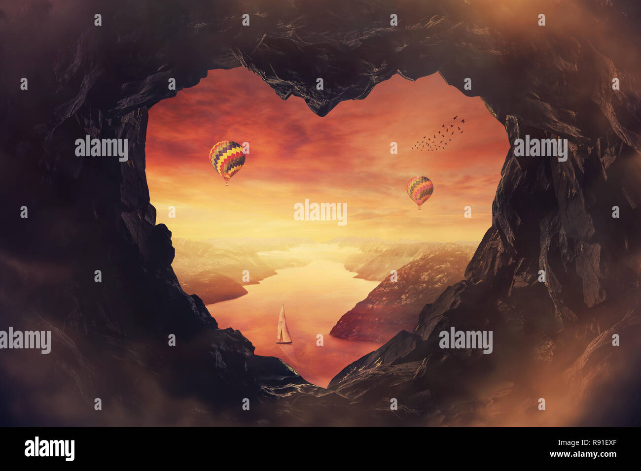 Scenery view through a heart shaped cave exit to a beautiful sunset ...