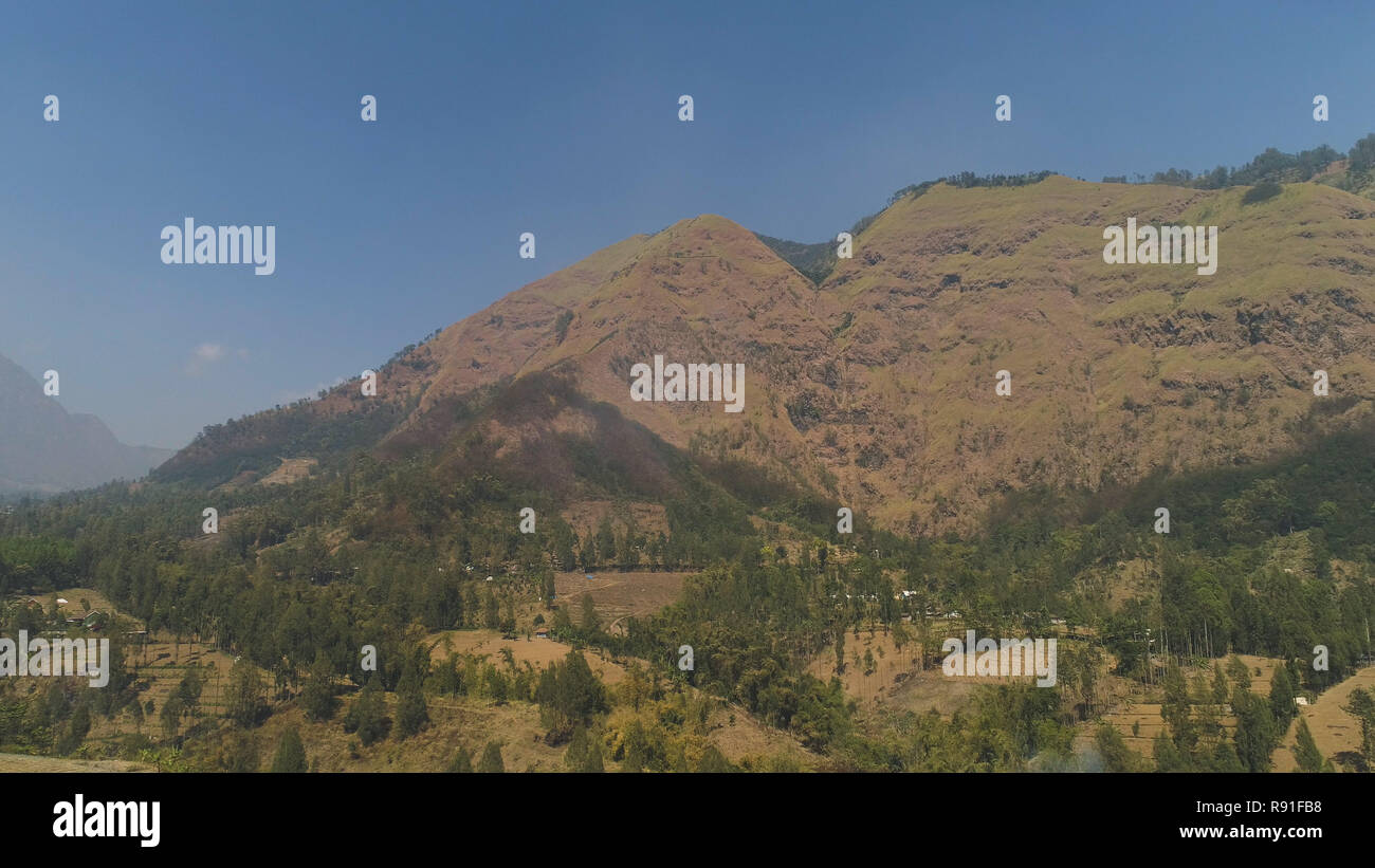 mountains with farmlands, village, fields with crops, trees. Aerial ...