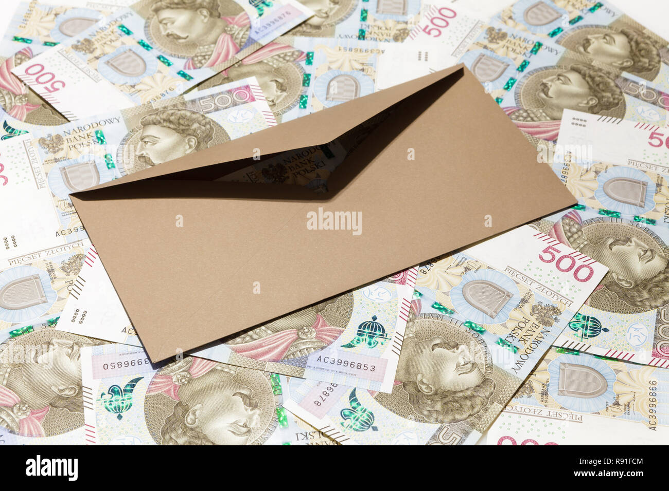 Brown opened envelope on 500 PLN banknotes background Stock Photo - Alamy
