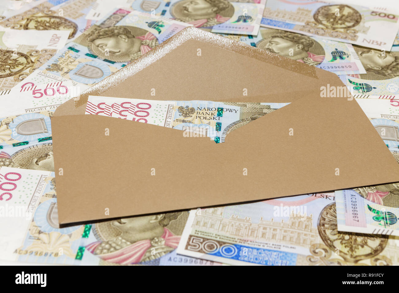 Brown envelope with 500 PLN banknotes on banknotes background Stock ...