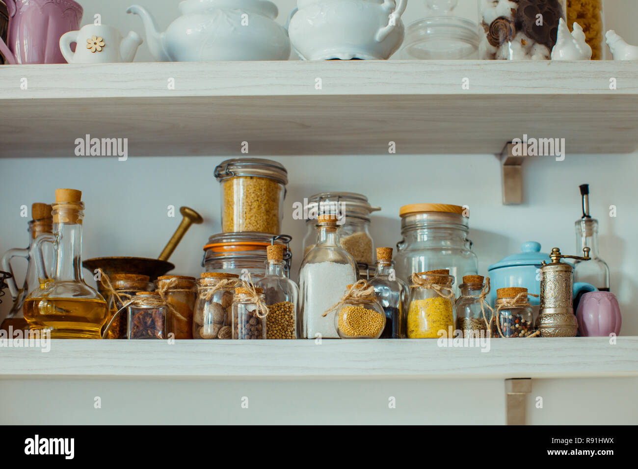 Modern kitchen shelves with various food ingredients on white ...