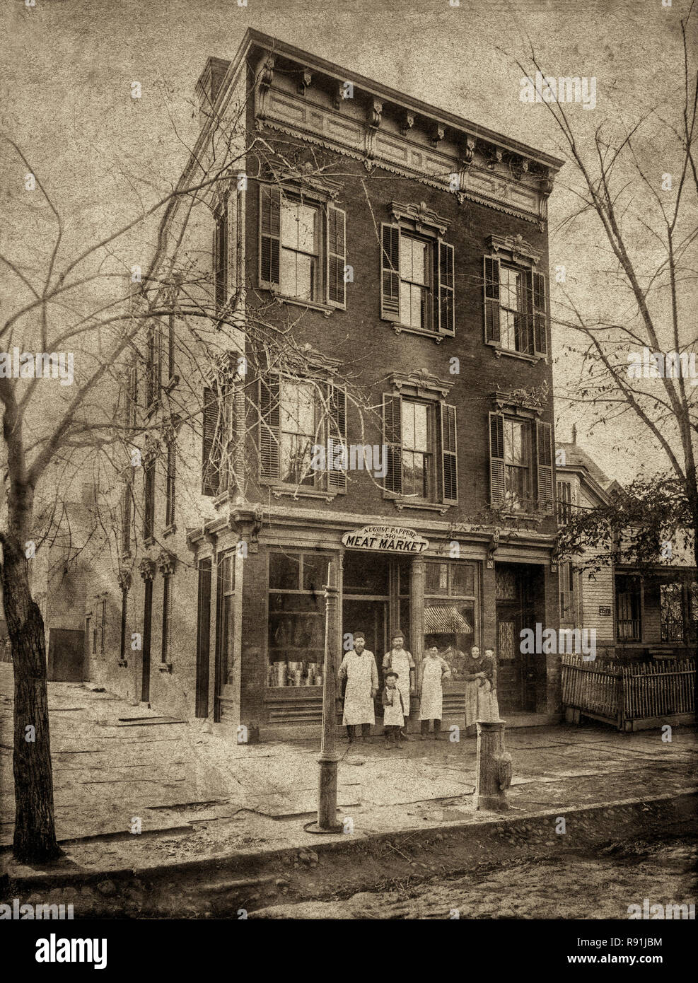 Restored photograph of a butcher shop with the employees assembled ...