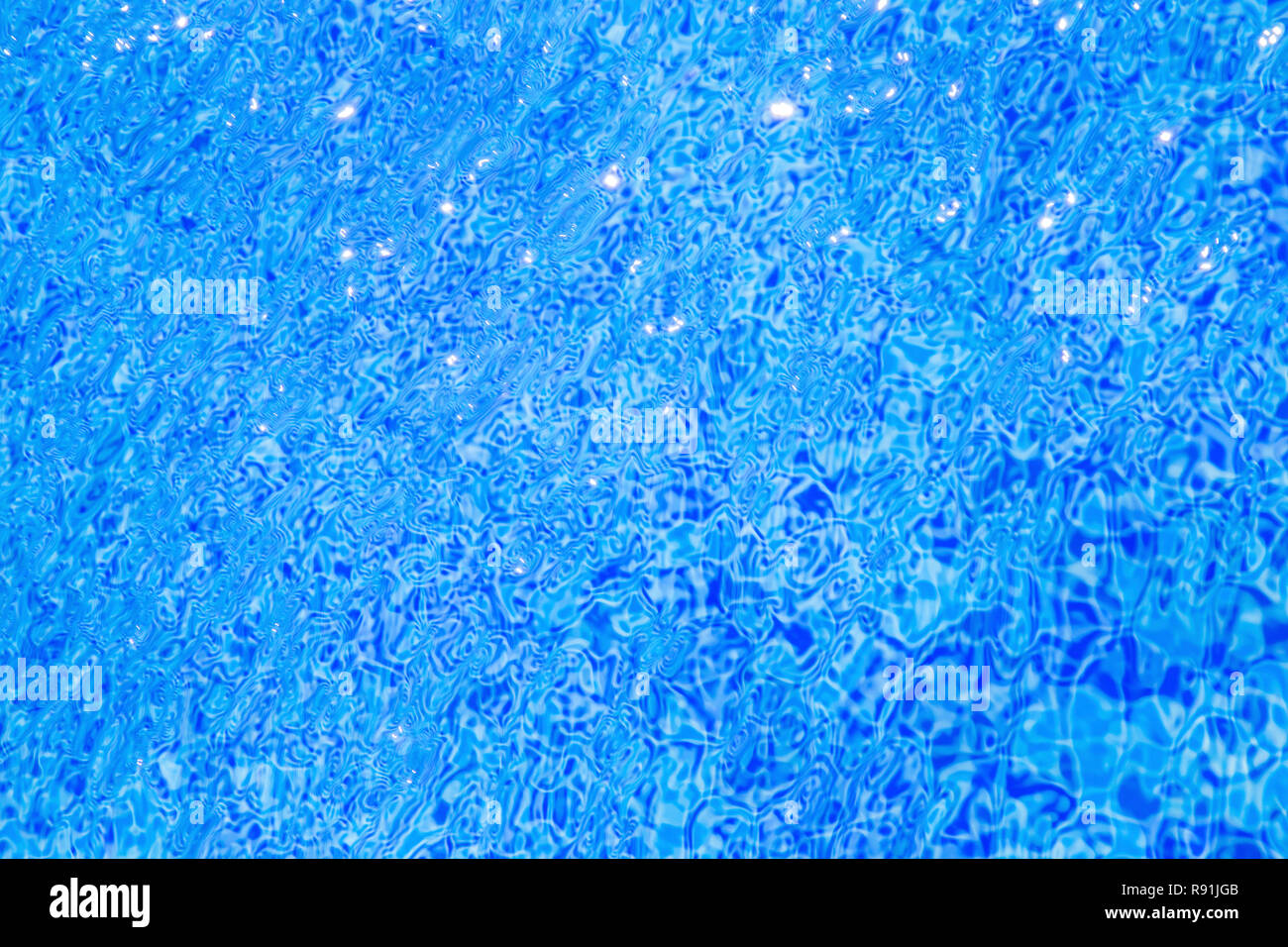 Ripple blue water in swimming pool witn sun reflection Stock Photo - Alamy
