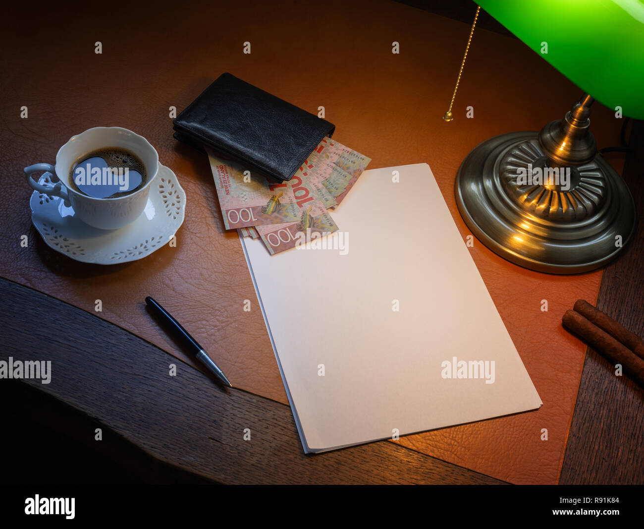 American dollars, on a stylish desk lit with a banking lamp Stock Photo ...