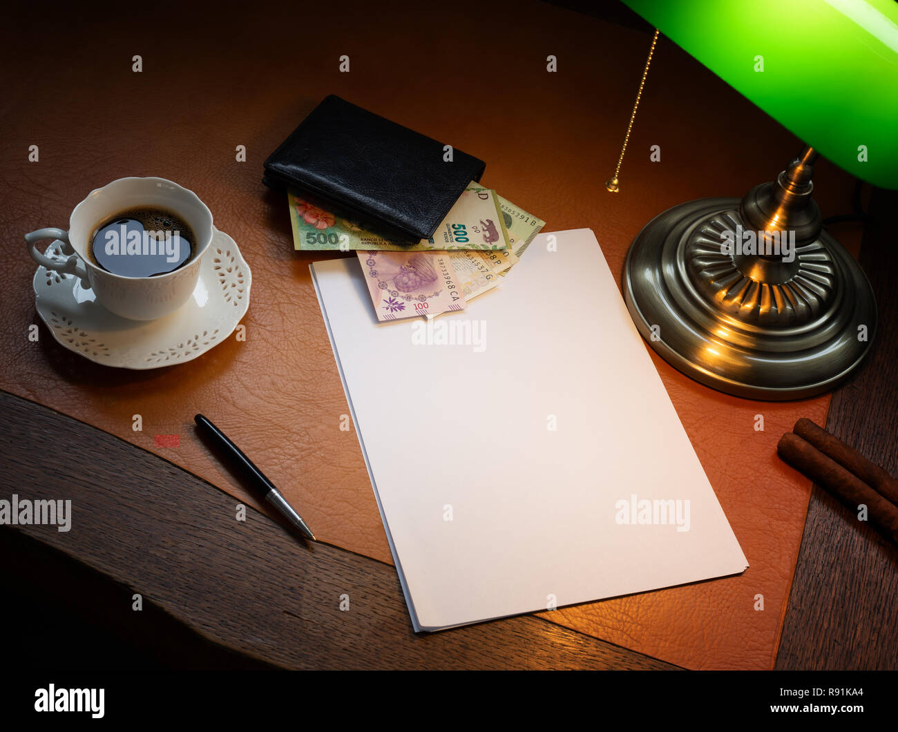 Argentine money, pesos, on a stylish desk lit with a banking lamp Stock ...