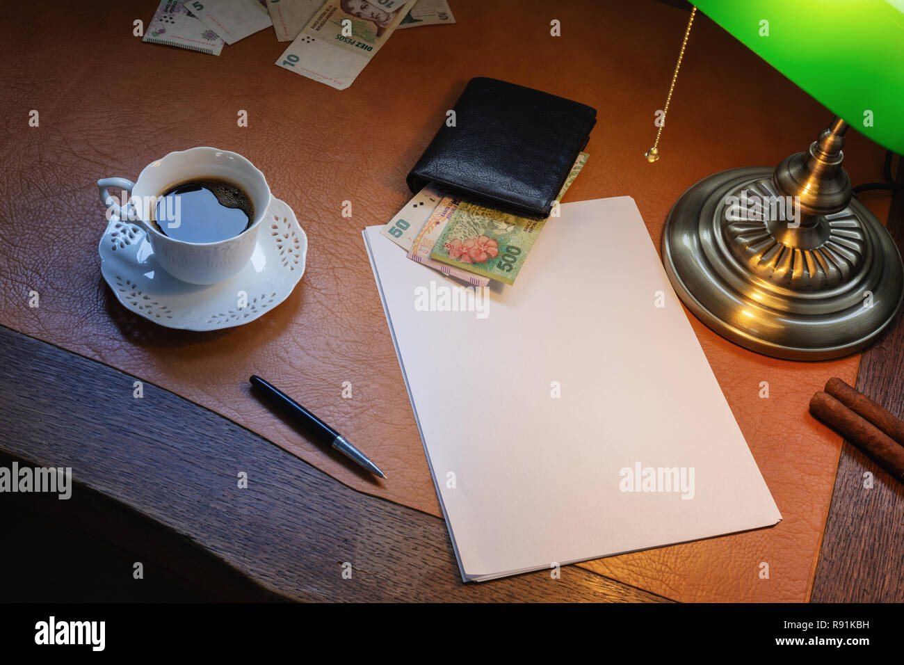 Argentine money, pesos, on a stylish desk lit with a banking lamp Stock ...