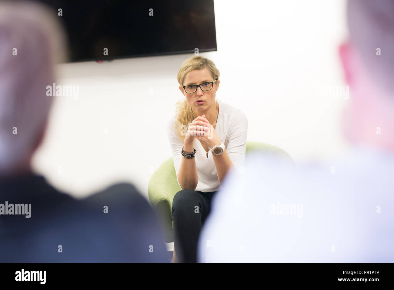 Female candidate presenting her CV in front of business job recuters ...