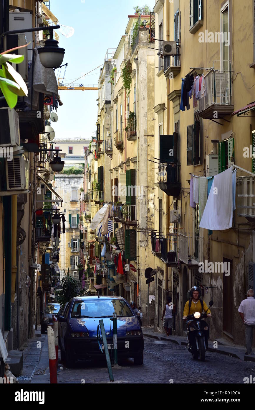 Narrow cobble stone paved streets with tall Mediterranean style ...