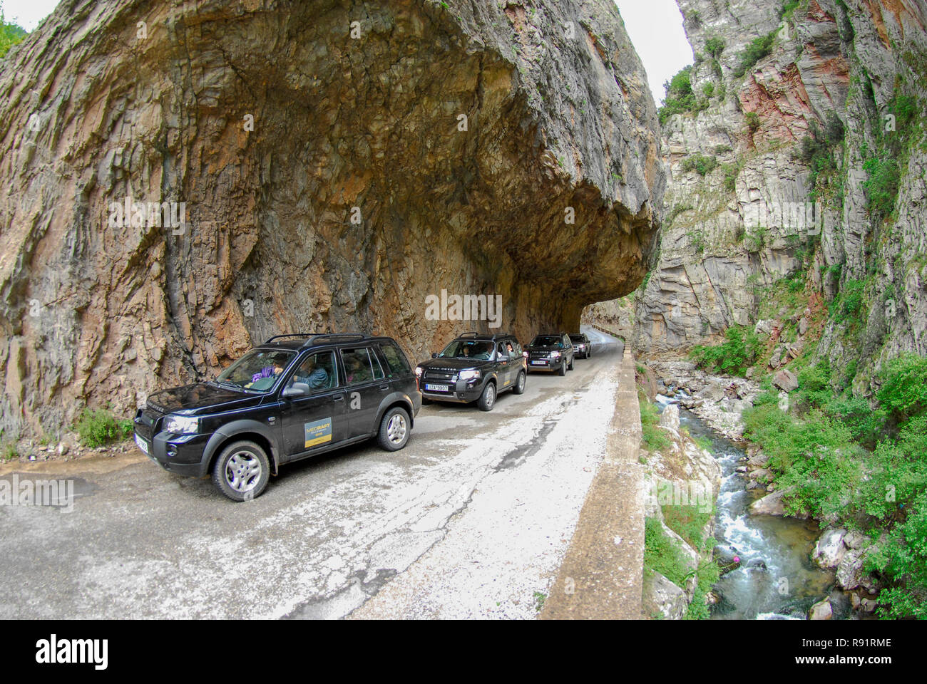 Mountainous road the cliff overhangs over the road. Photographed in ...