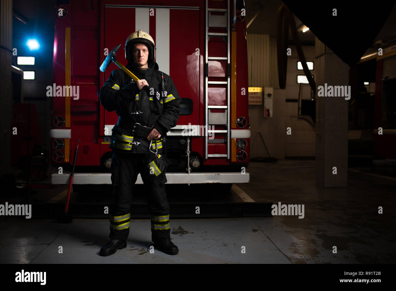 Photo of man fireman with pick on background of fire truck Stock Photo ...