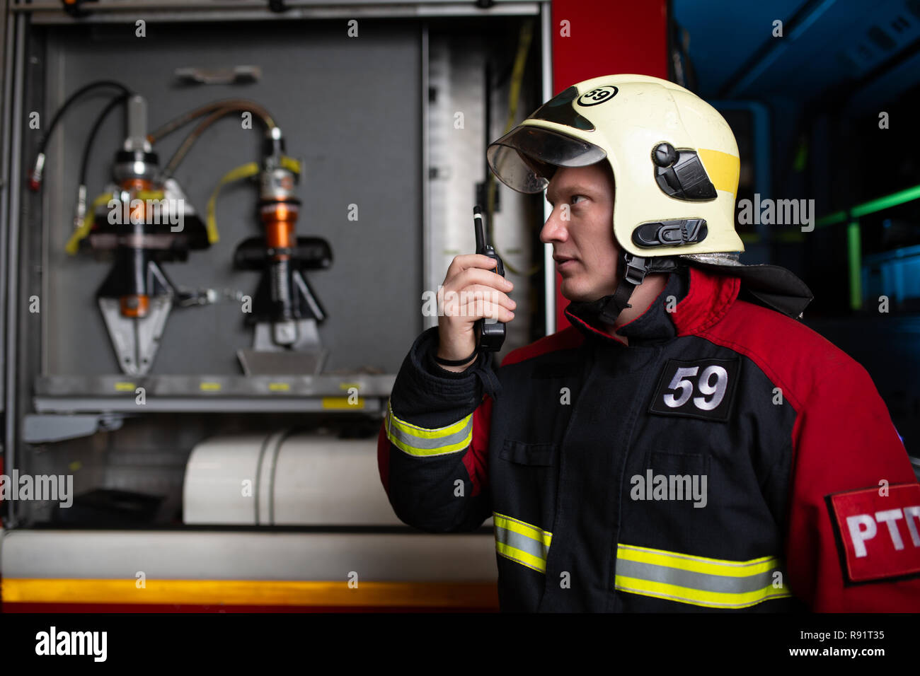 Image of male firefighter in helmet talking on walkie-talkie Stock ...
