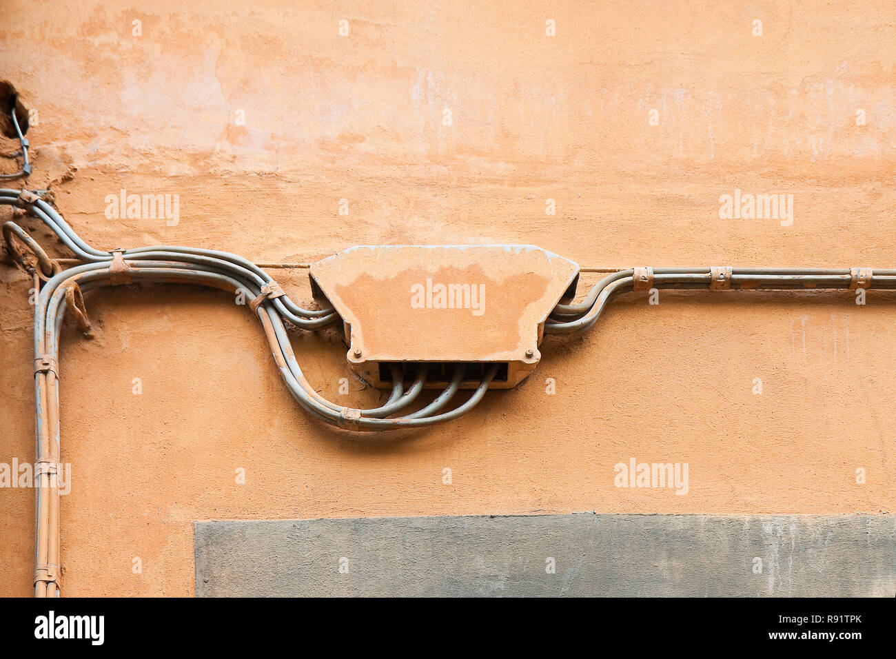 Electrical cables fixed on the wall for the distribution of electricity ...