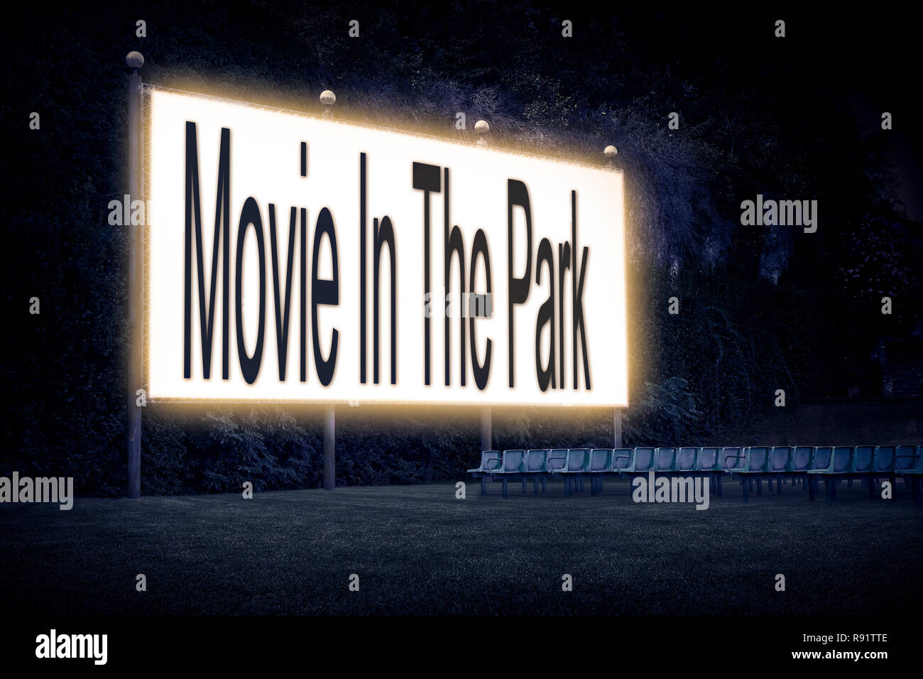 Outdoor cinema with chairs and white projection screen with 'Movie In ...