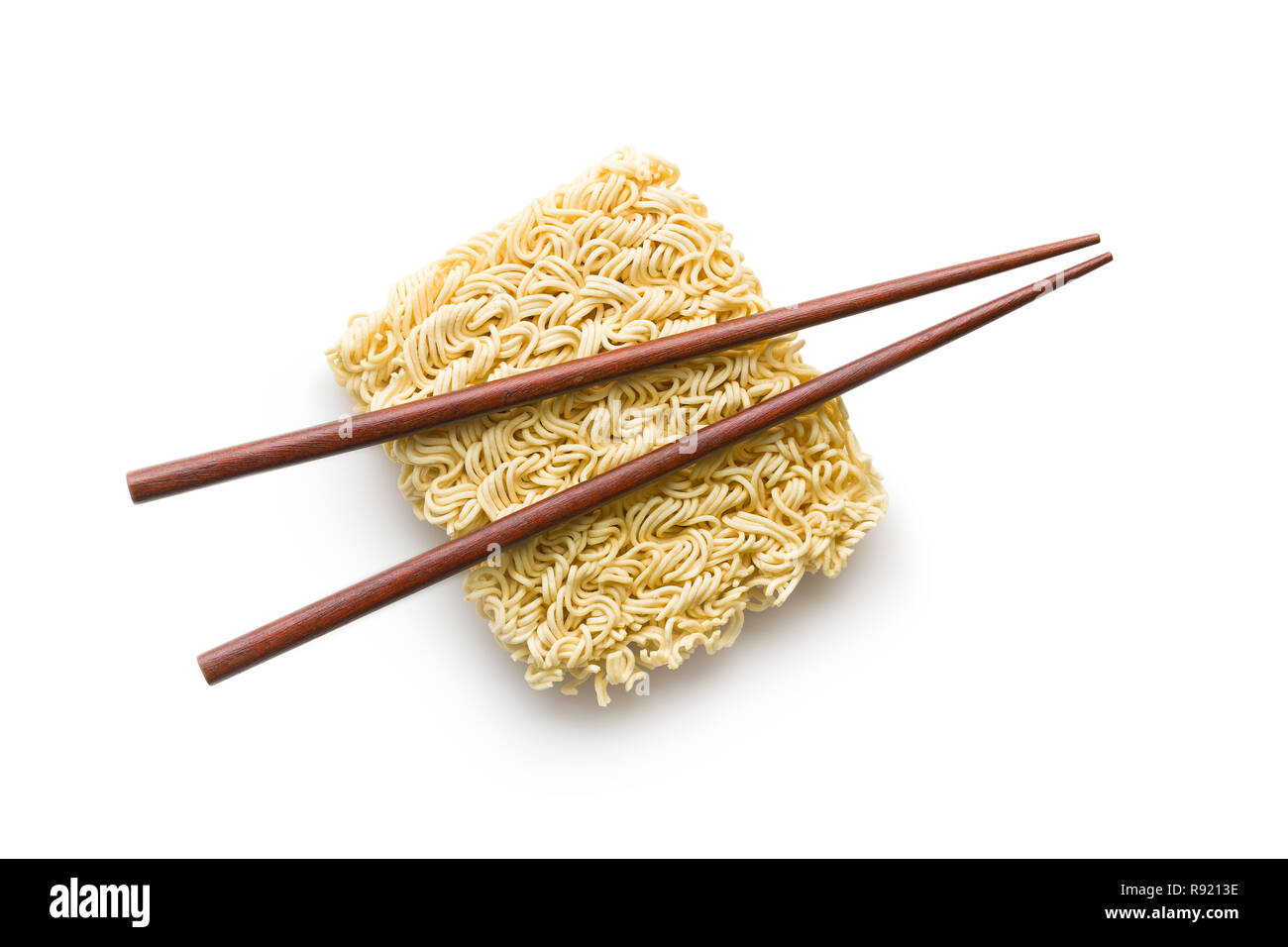 Uncooked instant noodles and chopsticks isolated on white background ...