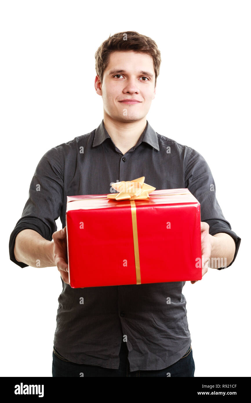 Holiday and special occasion. Young handsome man giving red present ...