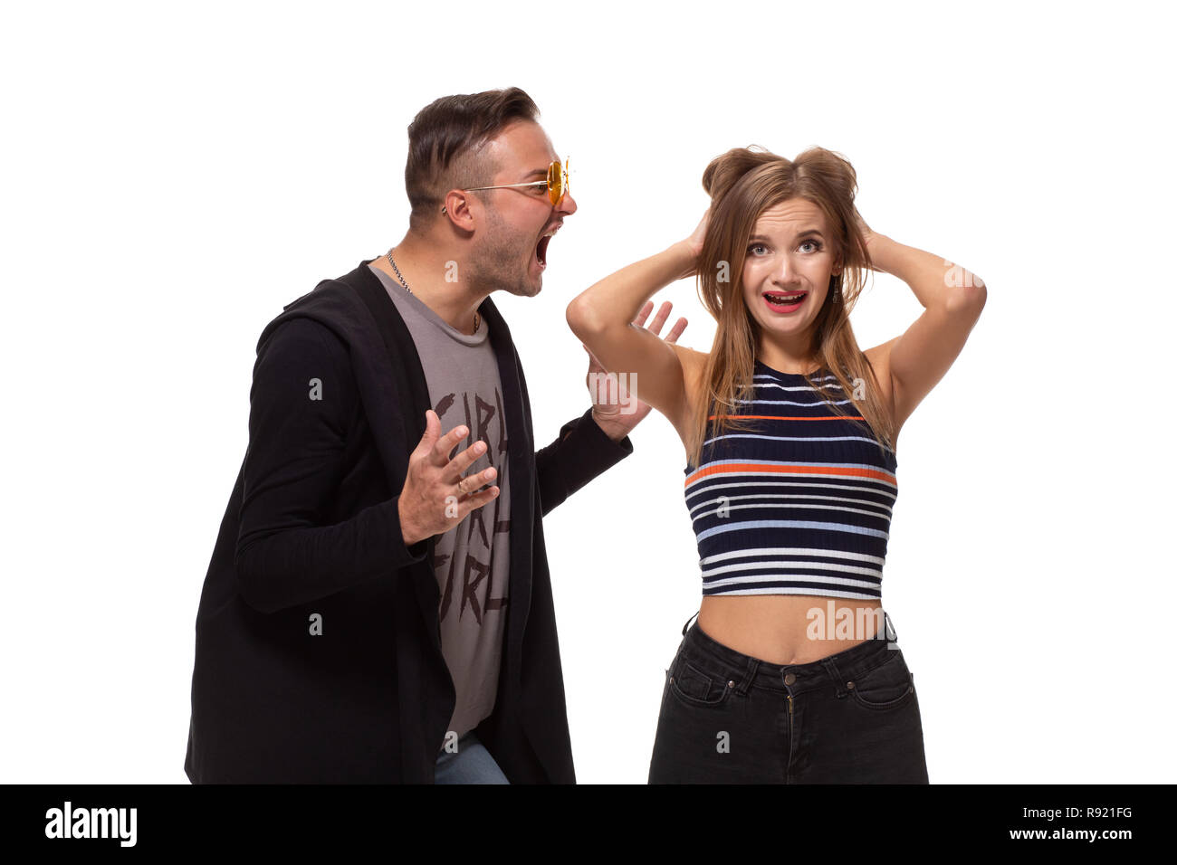 Young emotional man and woman quarrel. Man screaming at the woman ...