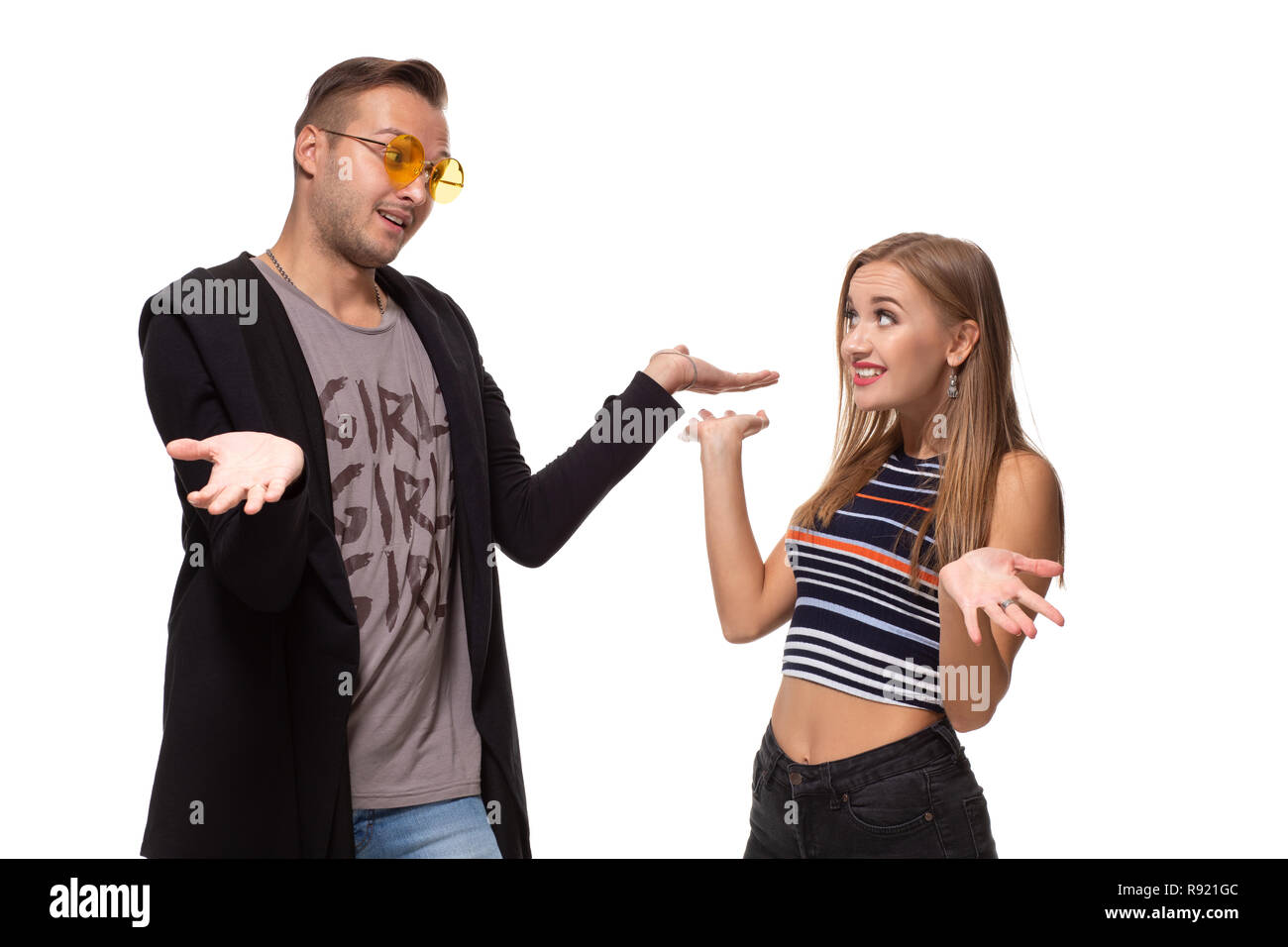 Portrait of cute young couple standing together, astonished with guilty ...
