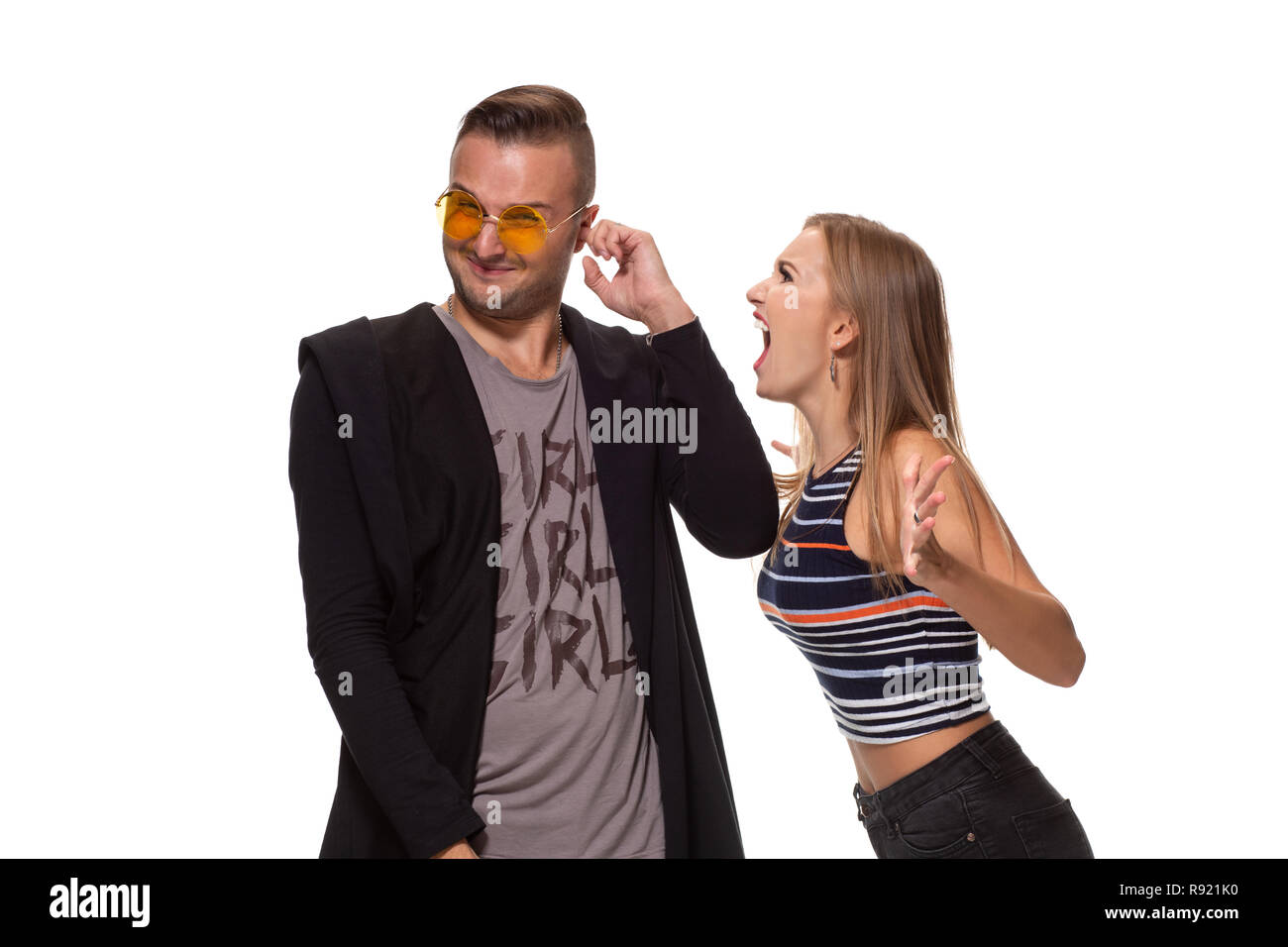 Angry blonde young European woman gestures with hands, shouts at ...