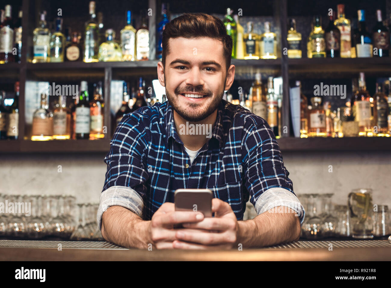 Male bartender leaning on bar hi-res stock photography and images - Alamy