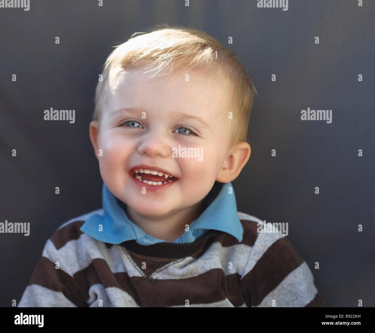 Head and shoulder portrait of happy young caucasian toddler child with ...