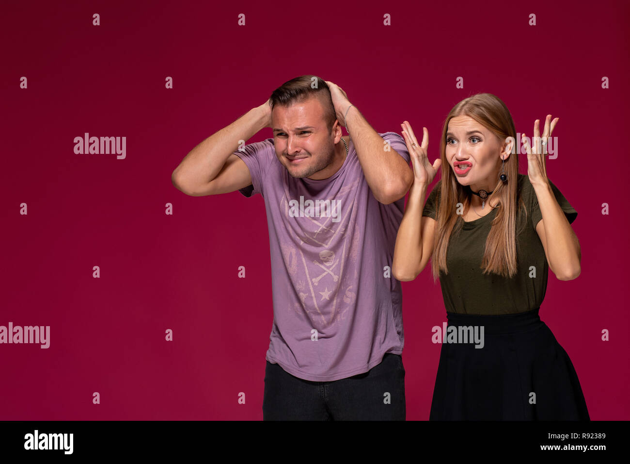 Unhappy discontent woman and man look with disgusting expression, as ...