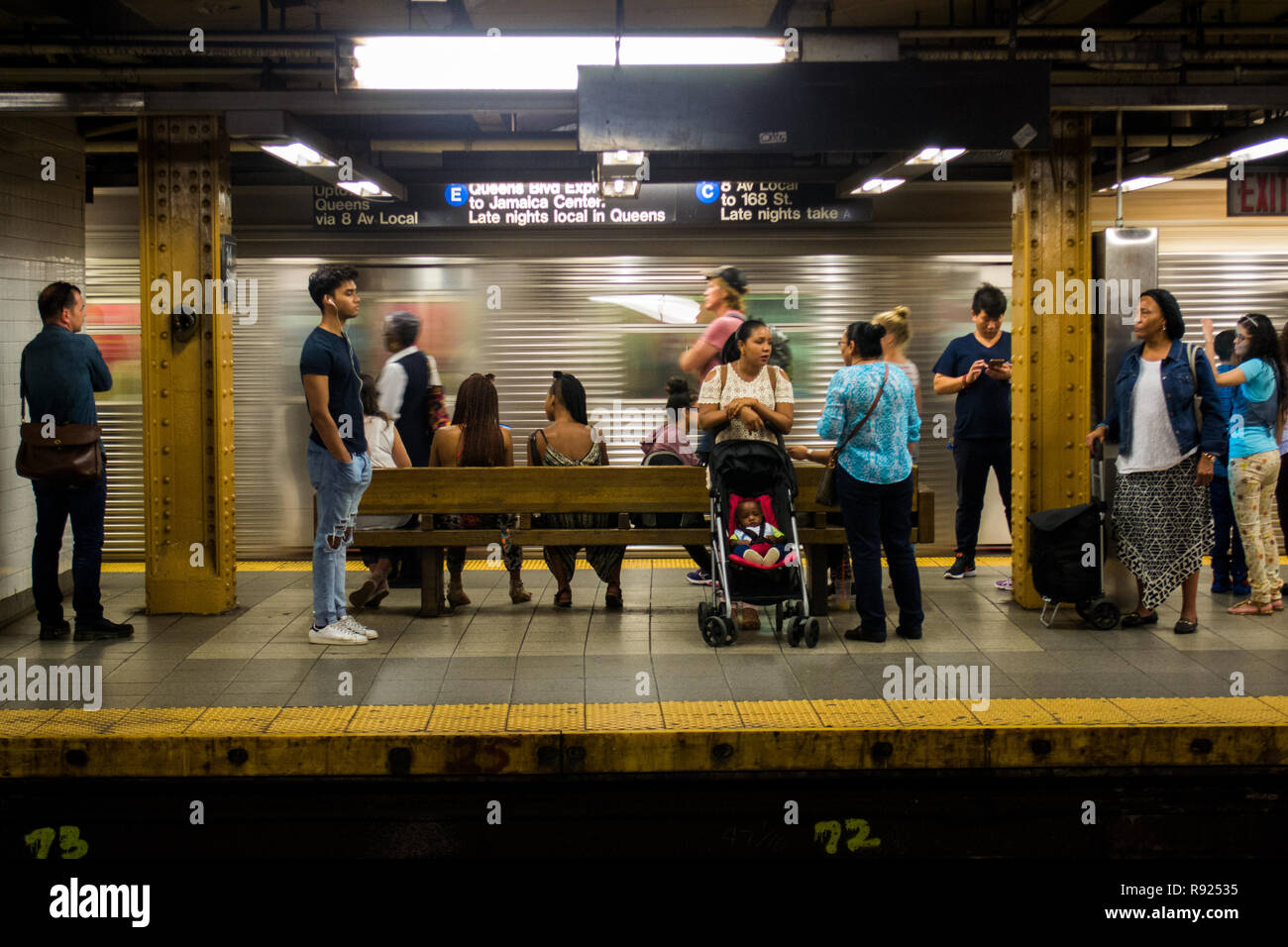 A Group of people waiting on the platform at the 14th street subway ...
