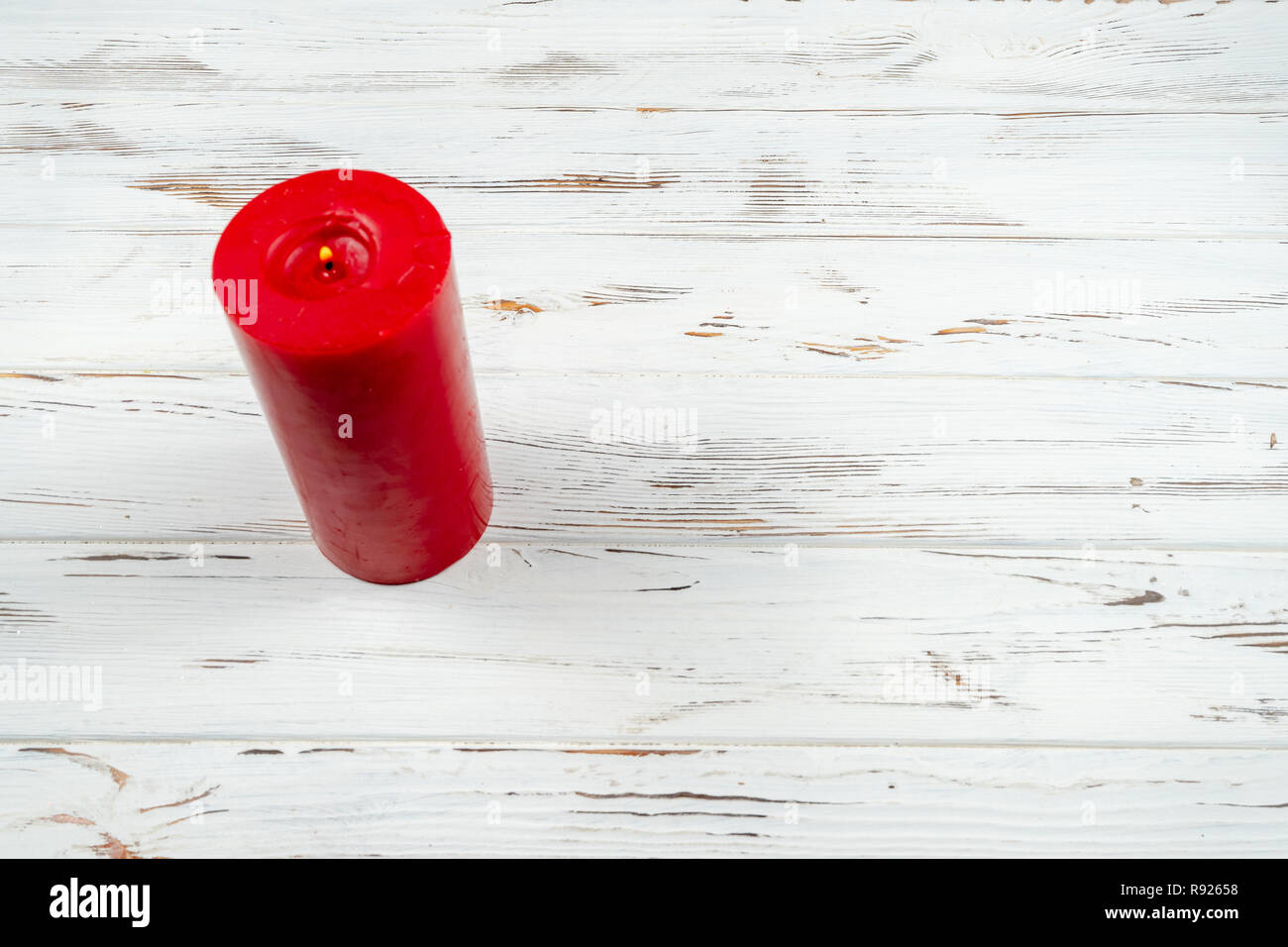 Burning Red Candle on white rustic background Stock Photo - Alamy