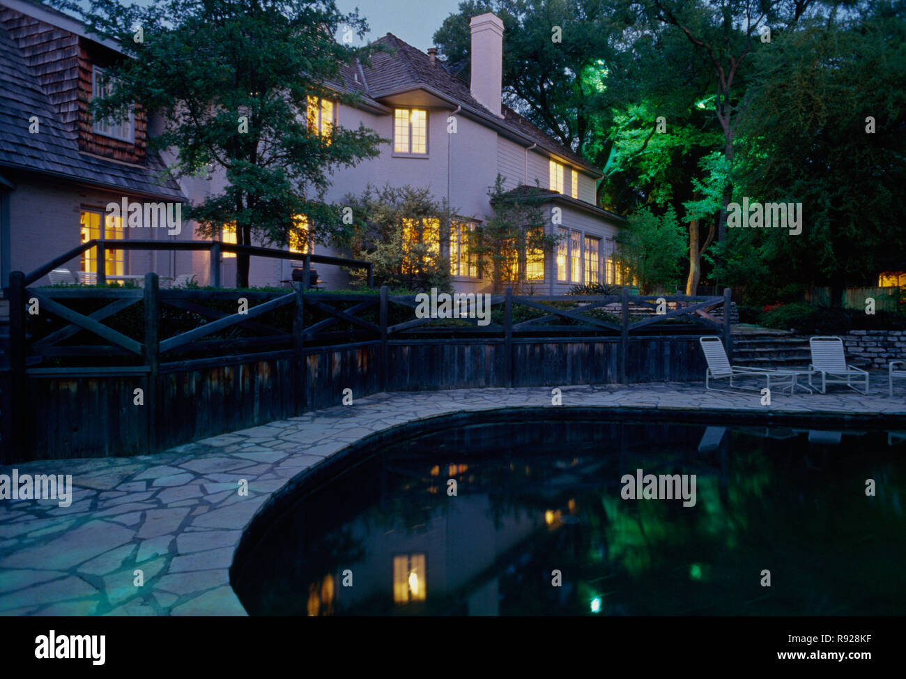 Swimming pool on the grounds of a mansion at dusk, Dallas, TX, USA ...