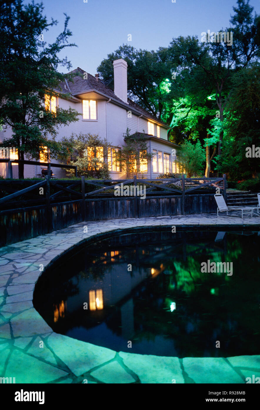 Swimming pool on the grounds of a mansion at dusk, Dallas, TX, USA ...