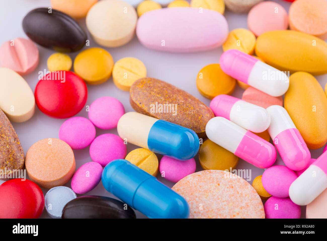 Tablets pills capsule heap mix therapy drugs, over a white background ...