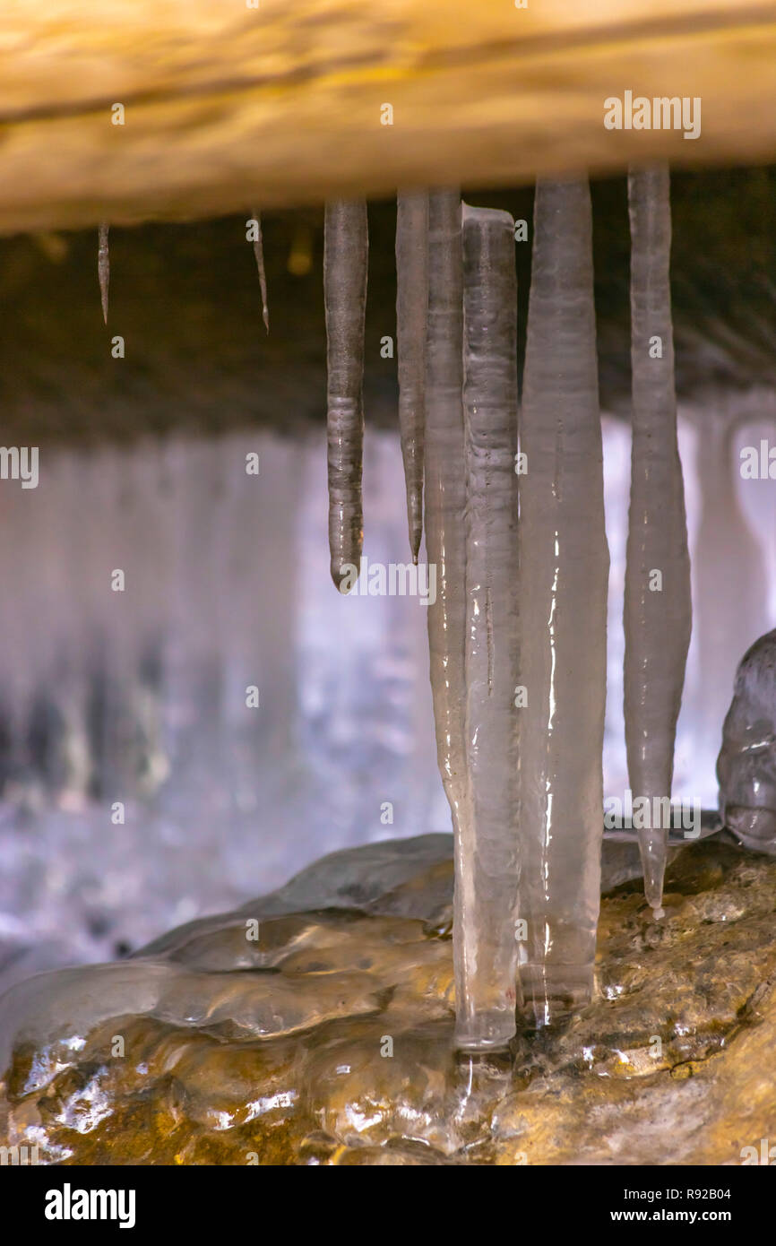 Long group of icicles forming below wooden bridge Stock Photo - Alamy