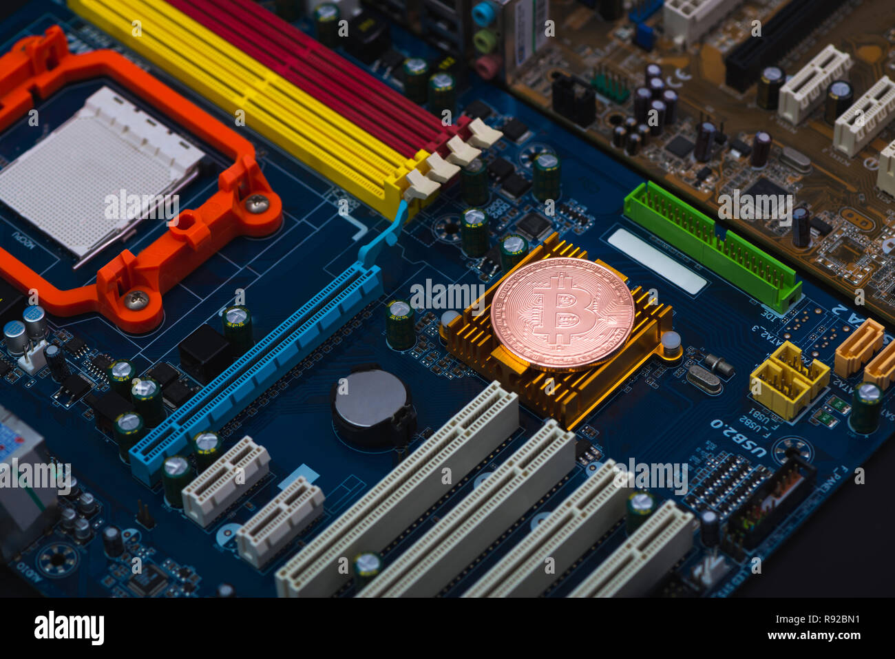 Bitcoin digital currency, bit-coin on motherboard or electronic board ...