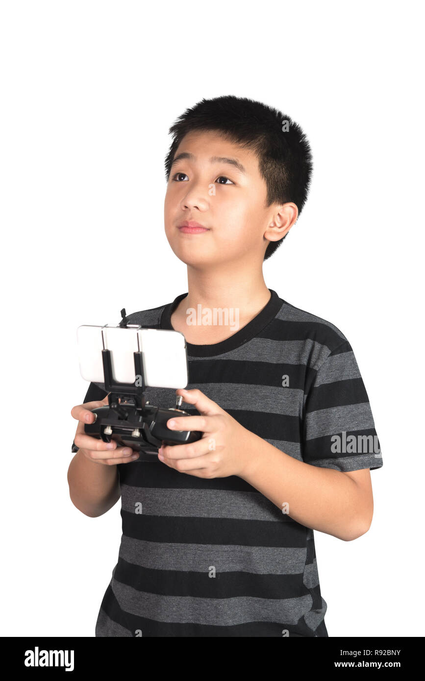 Asian boy holding radio remote control (controlling handset) for ...