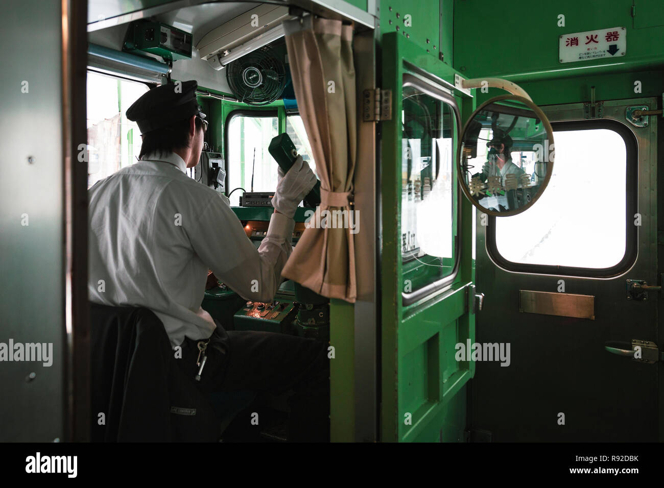 A train driver at Kutchan Station on the Japan Rail (JR) Hakodate line ...