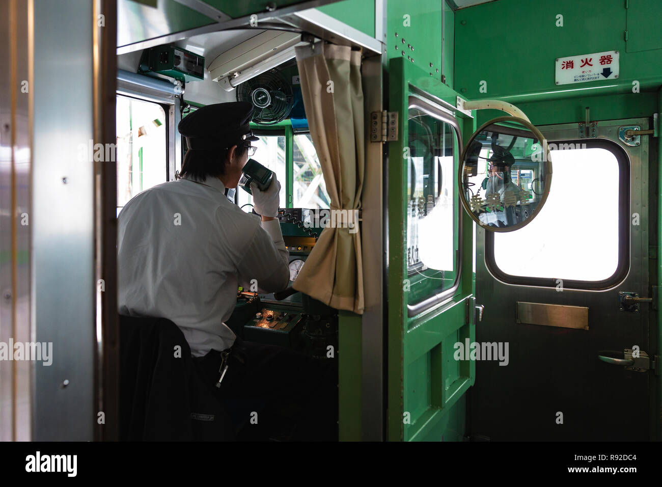 A train driver at Kutchan Station on the Japan Rail (JR) Hakodate line ...