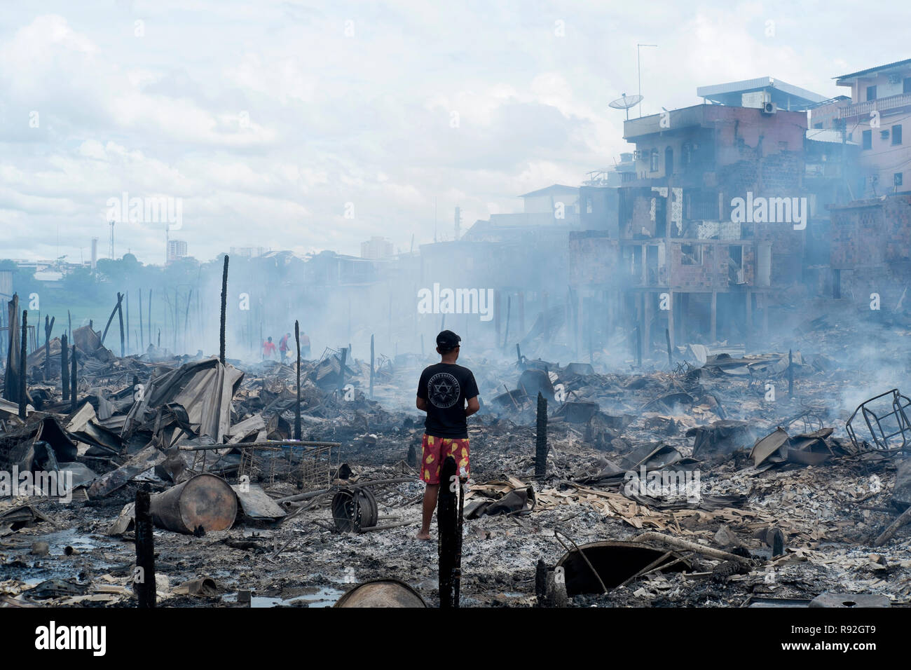 Manaus, Brazil. 18th Dec, 2018. A boy looks at the damage caused by a ...