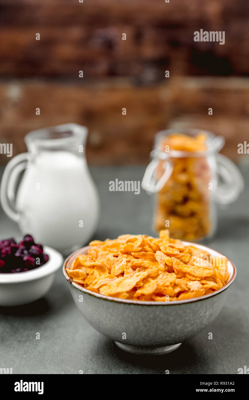 cornflakes cereal and milk in a glass. Morning tasty breakfast concept ...
