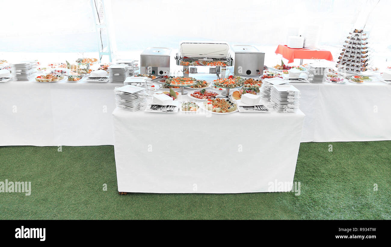 catering table set service with silverware and glass stemware in the ...