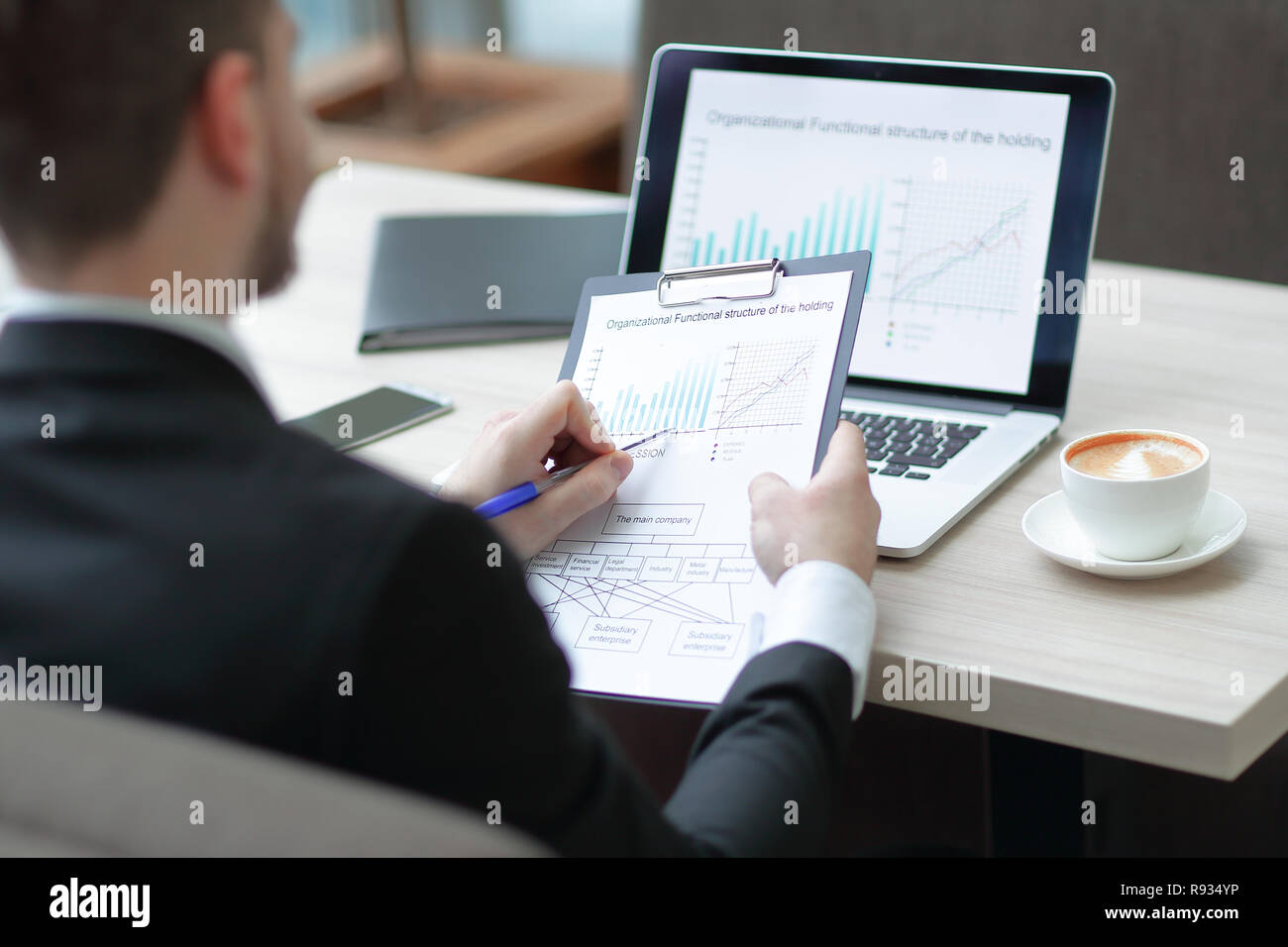 closeup.businessman checking financial documents sitting at the Desk ...
