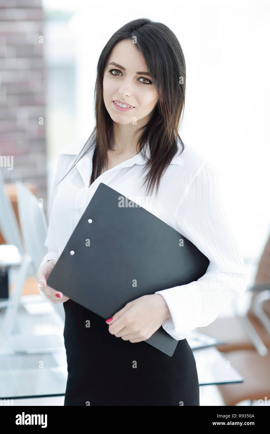 Executive business woman with documents on the background of the office ...